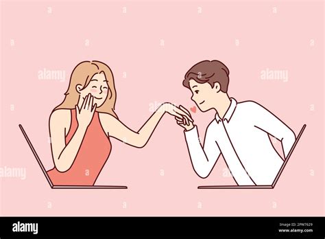 Determined Guy Kisses Hand Of Embarrassed Girl Looking Out Of Laptop