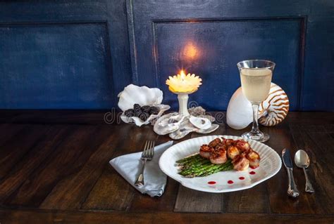 Candied Bacon Wrapped Sea Scallops Over A Bed Of Asparagus On Fine