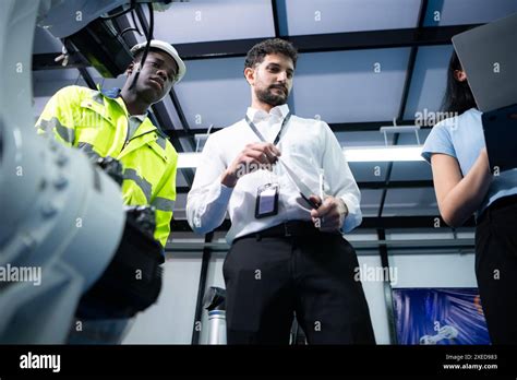 Technicians Are Introducing Industrial Hand Robots To Businessperson Of