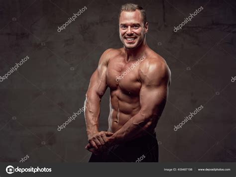 Joyful Bodybuilder Showing His Perfect Body In Studio Stock Photo By