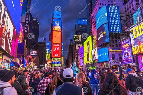 Times Square At Night With Bright Digital Billboards Crowds Of