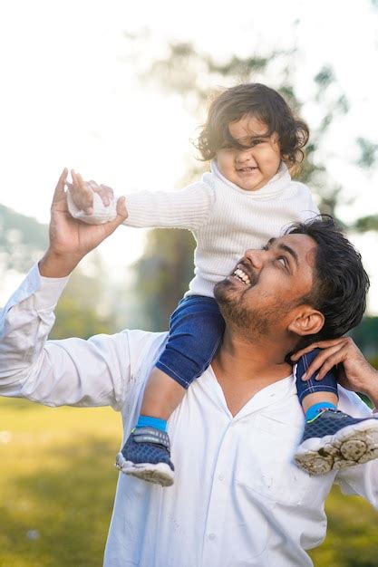 Premium Photo Father And Son Playing In The Park At The Sunset Time
