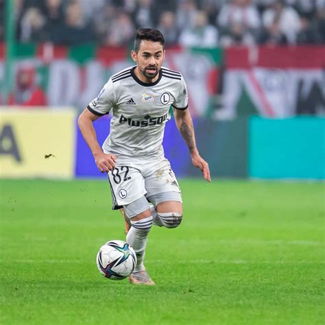 Download Soccer Player Controling Ball During Match Wallpaper