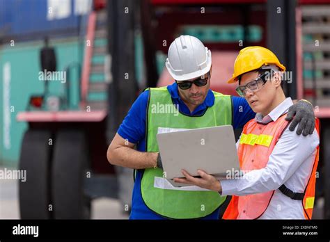 Engineer People Work In Port Cargo Container Shipping Yard Using Laptop