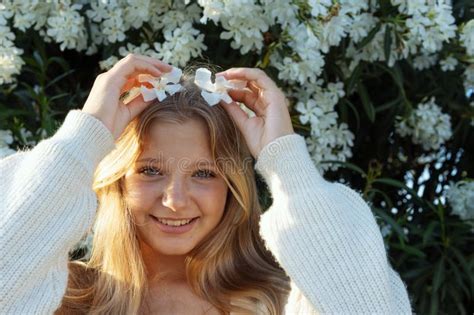 Portrait Of A Teenage Girl Of European Blonde Hair Stands On The