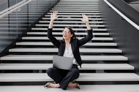 Premium Photo Portrait Of Young Woman Sitting On Staircase