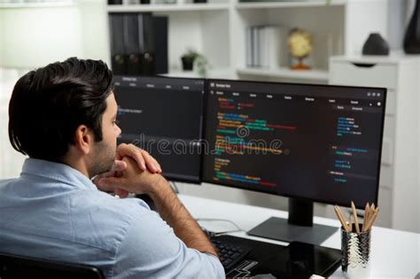 Concentrating In Smart It Developer Working Coding On Two Pc Screen Surmise Stock Image