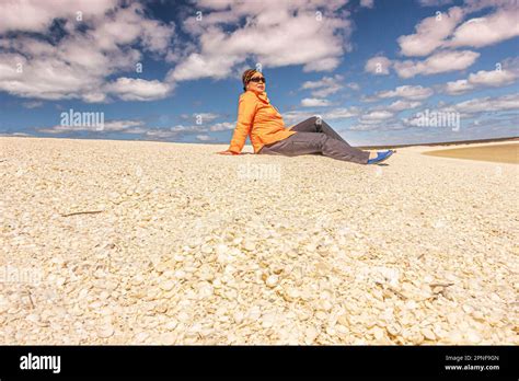 A Woman Sitting Relaxed On Pile Of Sea Shell At Shell Beach In Shark