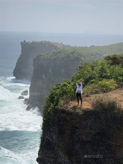Tiny Woman On High Cliff Above Indian Ocean Amazing Nature Stock Photo By Mariiaplosh
