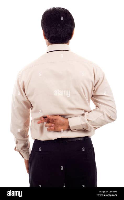 Asian Businessman With Fingers Crossed Behind Back Isolated Over White Background Stock Photo