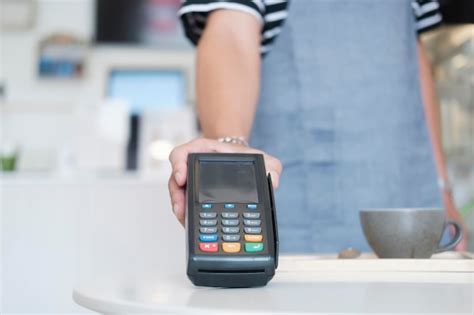 Premium Photo Close Up Hand Holding The Nfc Payment Terminal