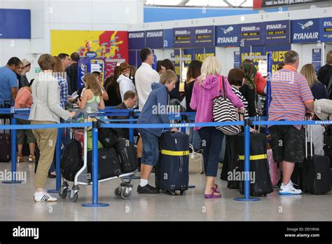 Passengers At Stansted Airportessexin The Departure Terminal Waiting