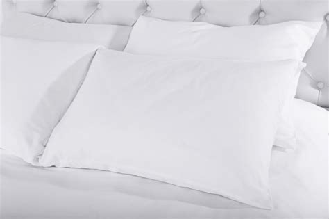 Premium Photo White Pillows On Bed Close Up