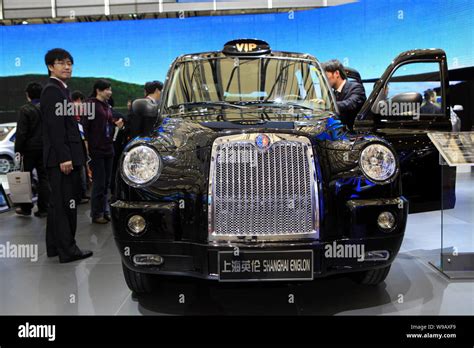 File Visitors Look At A Shanghai Englon Tx4 Cab Of Geely At The 13th