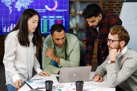 A Team Of Young Multinational Business People Are Working On A Startup
