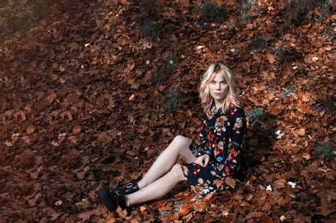 Premium Photo Emotionless Woman In Dress Sitting On Fallen Leaves