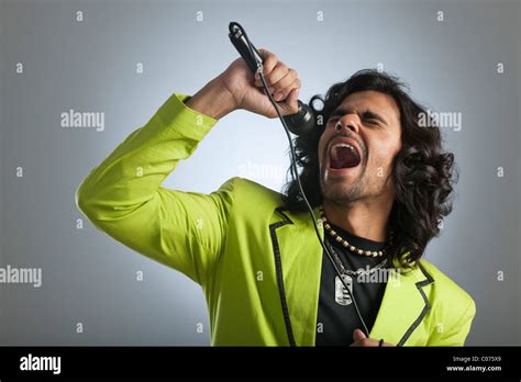 Man Singing Into A Microphone Stock Photo Alamy