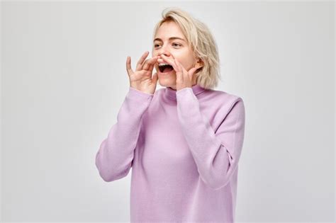 Premium Photo Portrait Of Blonde Girl Shouting Loudly With Hands News