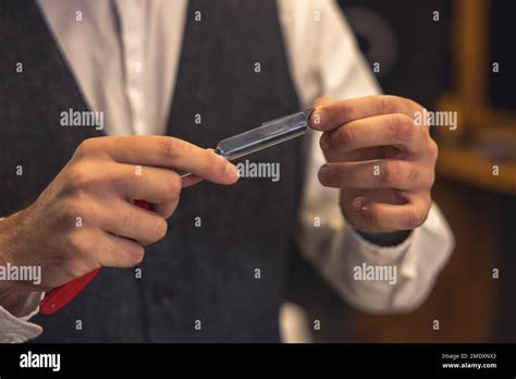 Barber Checking The Razor Sharpness Stock Photo Alamy