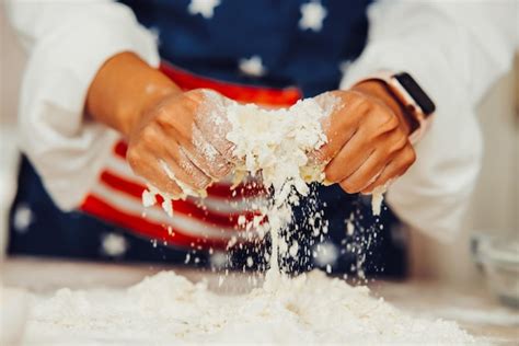 Premium Photo Young Housewife In An Apron Kneads Dough With Her Hands