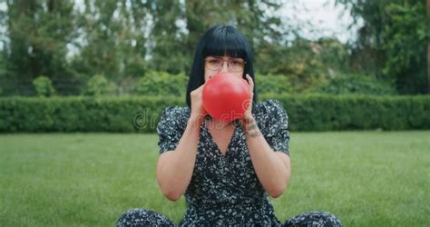 A Happy Woman Inflates Balloons And They Burst Showing That Everything