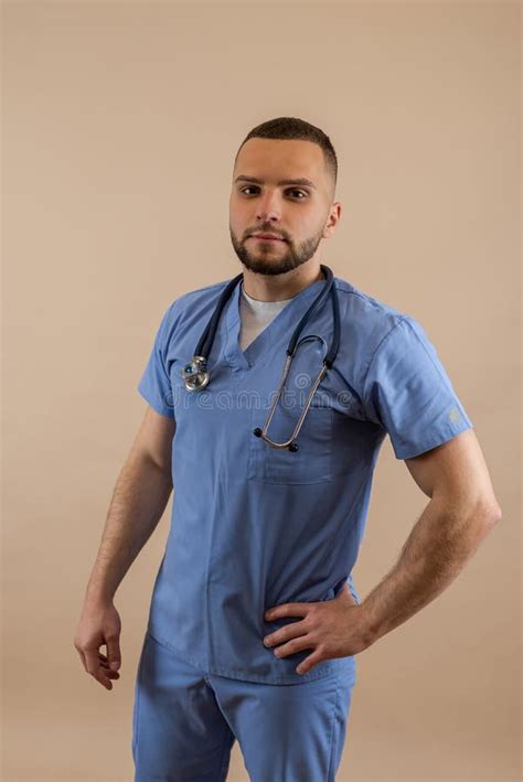 Portrait Of Caucasian Young Male Doctor In Blue Uniform With