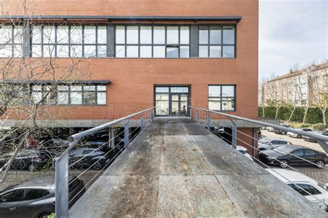 Access Walkway To An Office Building With Light Brown Brick Walls