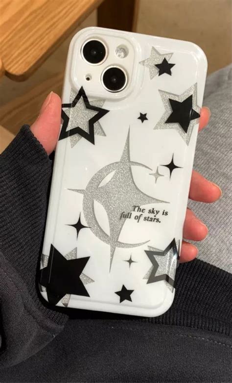 Someone Is Holding Up Their Phone Case With Stars On It