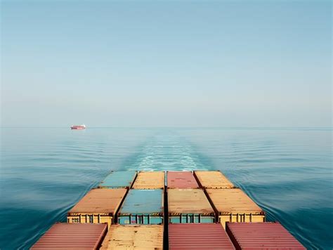 Premium Photo Container Cargo Freight Ship With Working Crane Bridge