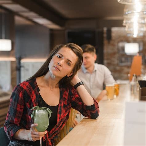 Free Photo Young Woman Holding Glass Of Cocktail At Pub