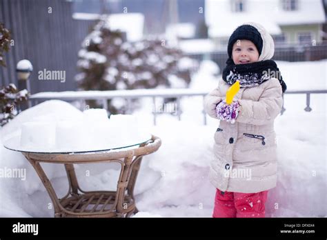 Little Funny Adorable Girl Having Fun And Playing In The Yard At Winter
