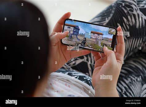 PUBG PlayerUnknowns Battlegrounds Mobile IOS Game On IPhone Smartphone Screen In Female Hands