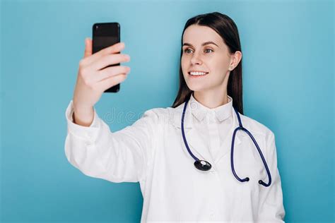 Confident And Successful Woman Doctor Or Medic Taking Selfie With