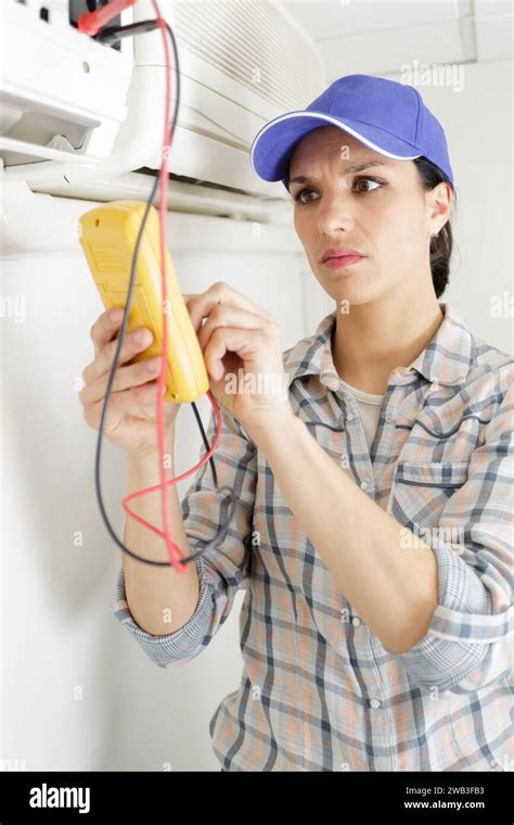 Female Maintenance Engineer Testing Voltage With Digital Multimeter Stock Photo Alamy