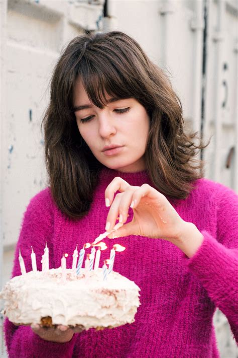 Girl Lighting Candles On Birthday Cake By Stocksy Contributor Danil