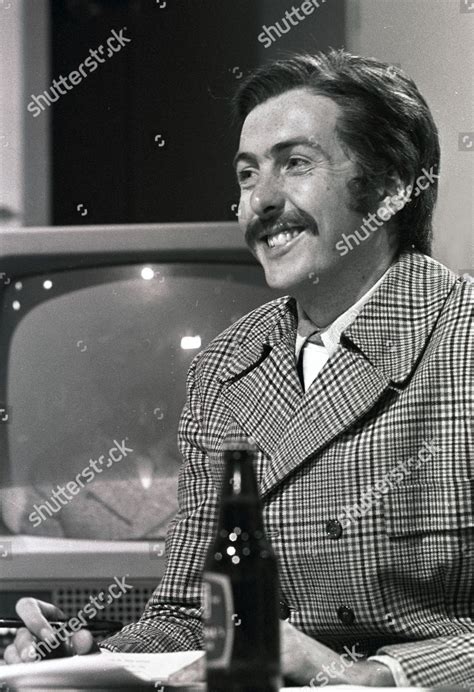 An Old Photo Of A Man Sitting In Front Of A Tv With A Bottle Of Beer