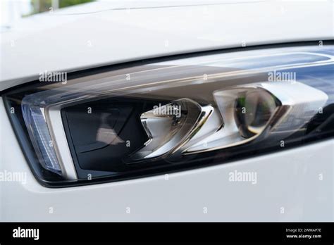 A Detailed Close Up View Of A Modern Cars Headlight Showing The