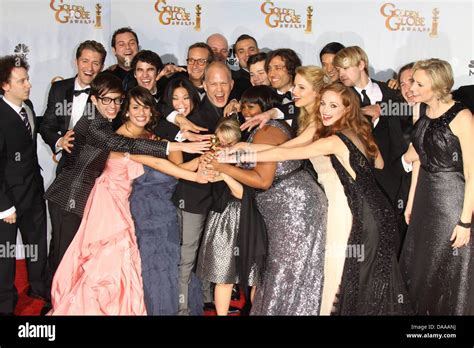 Cast Members Of Glee Pose With The Award For Best Television Series