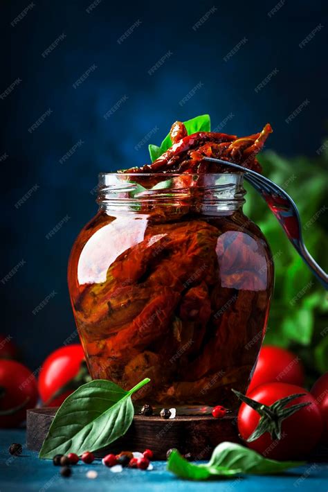Premium Photo Italian Sun Dried Tomatoes In Olive Oil With Green