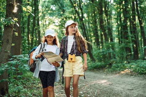 Premium Photo Using The Map Two Girls Is In The Forest Having A