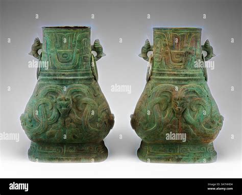 Two Intricately Designed Ancient Bronze Vessels Stand Side By Side