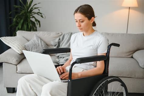 Premium Photo Female Freelance Programmer Sitting In Wheelchair And Using Computers While