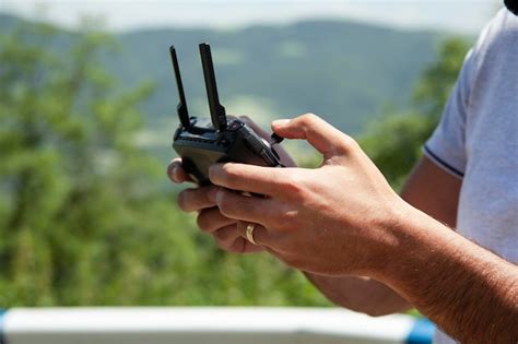 premium photo man holding drone remote control