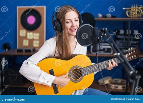 Young Caucasian Woman Musician Singing Song Playing Classical Guitar At