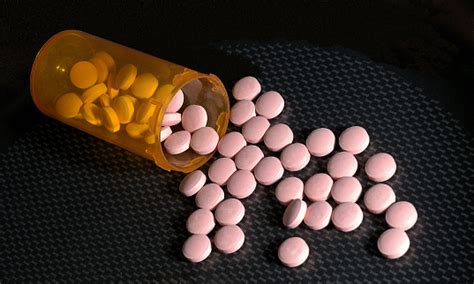 Lithium Tablets Spilled From A Prescription Medication Container Onto A Black And Grey Surface