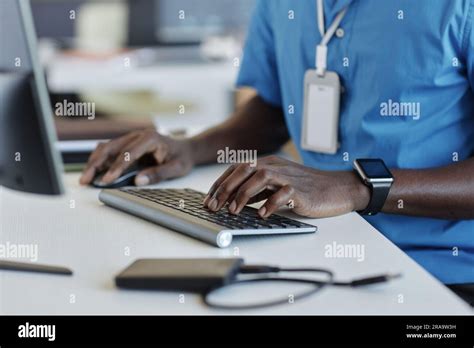 Focus On Left Hand Of Young African American Male Software Developer Touching Keys Of Computer