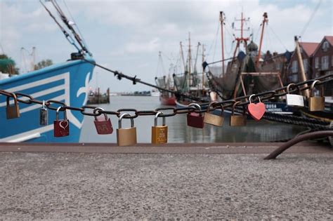 Premium Photo Love Locks Hanging On Chain At Harbor