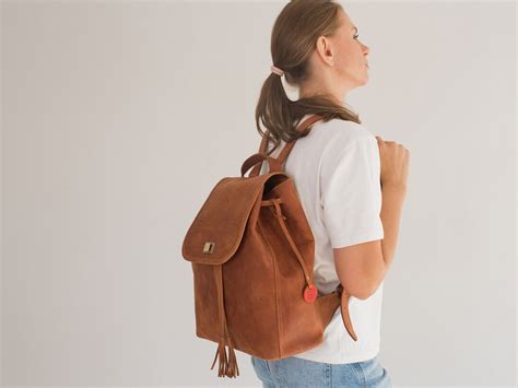Tassel Drawstring Backpack With Twist Lock Made Of Leather In Two Sizes