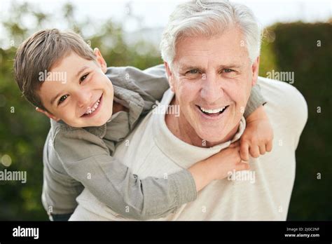 Is Your Granddad As Cool As Mine A Mature Man Carrying His Son On His