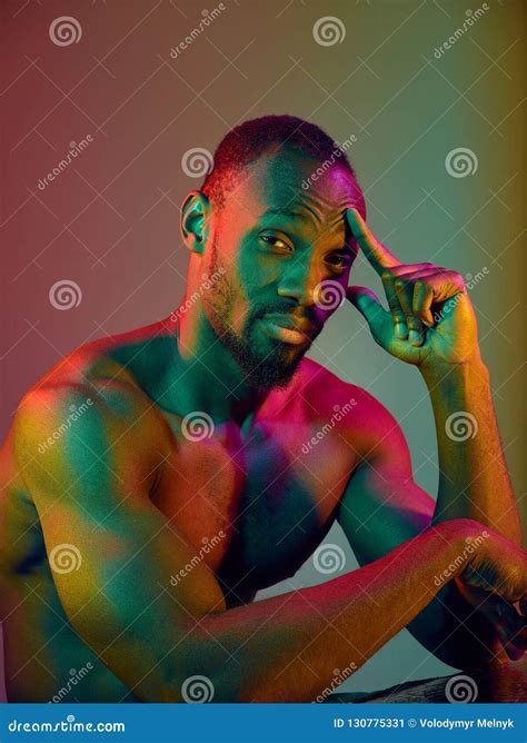 Close Up Portrait Of A Young Naked African Man Looking At Camera